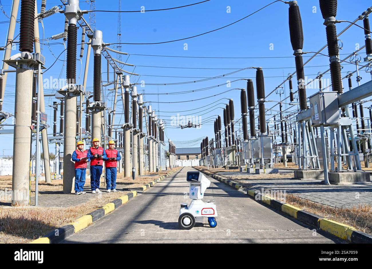 A 5G intelligent inspection robot and staff use a drone to conduct a ...