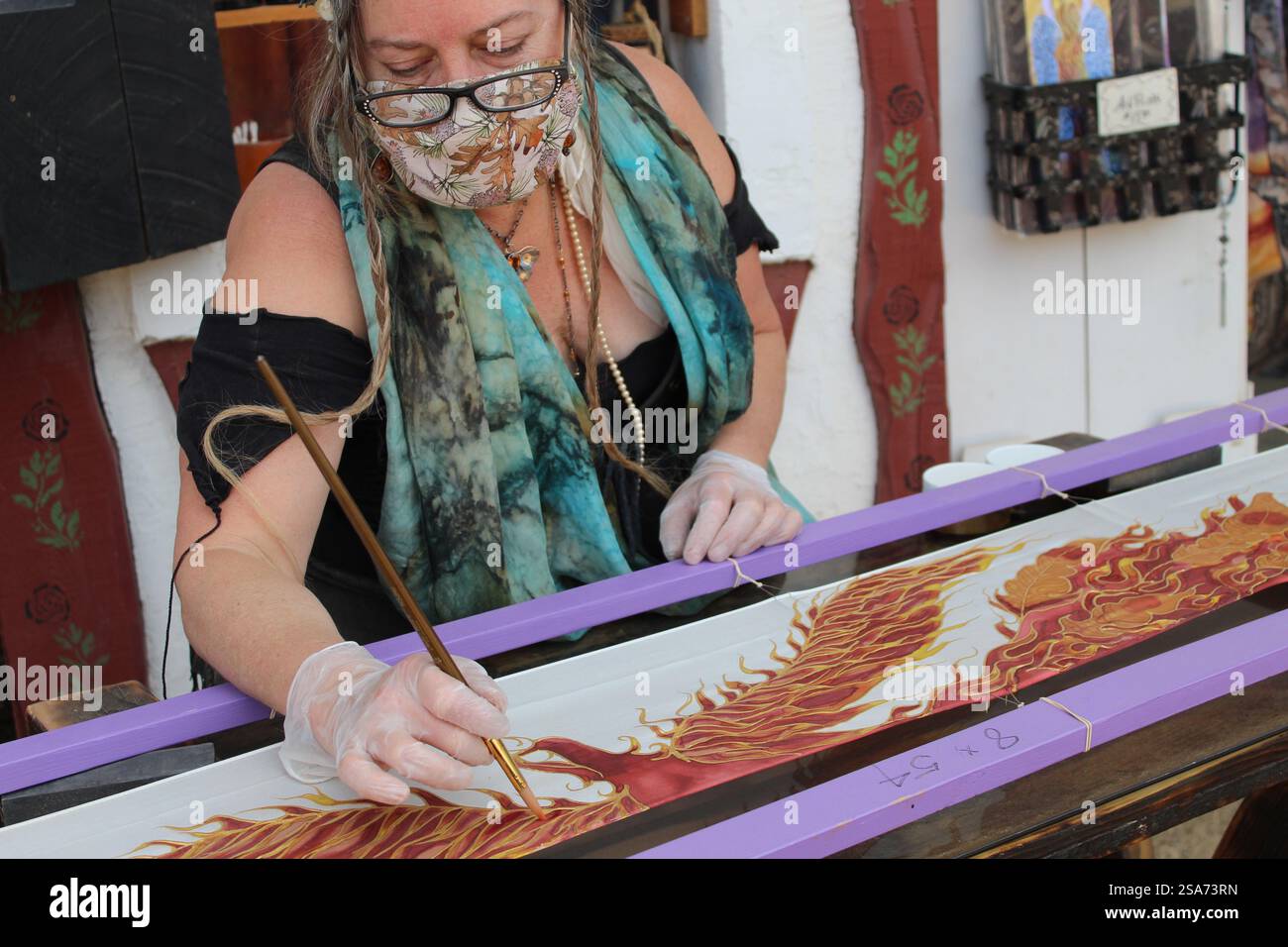 Artist hand painting a Phoenix on silk Stock Photo - Alamy