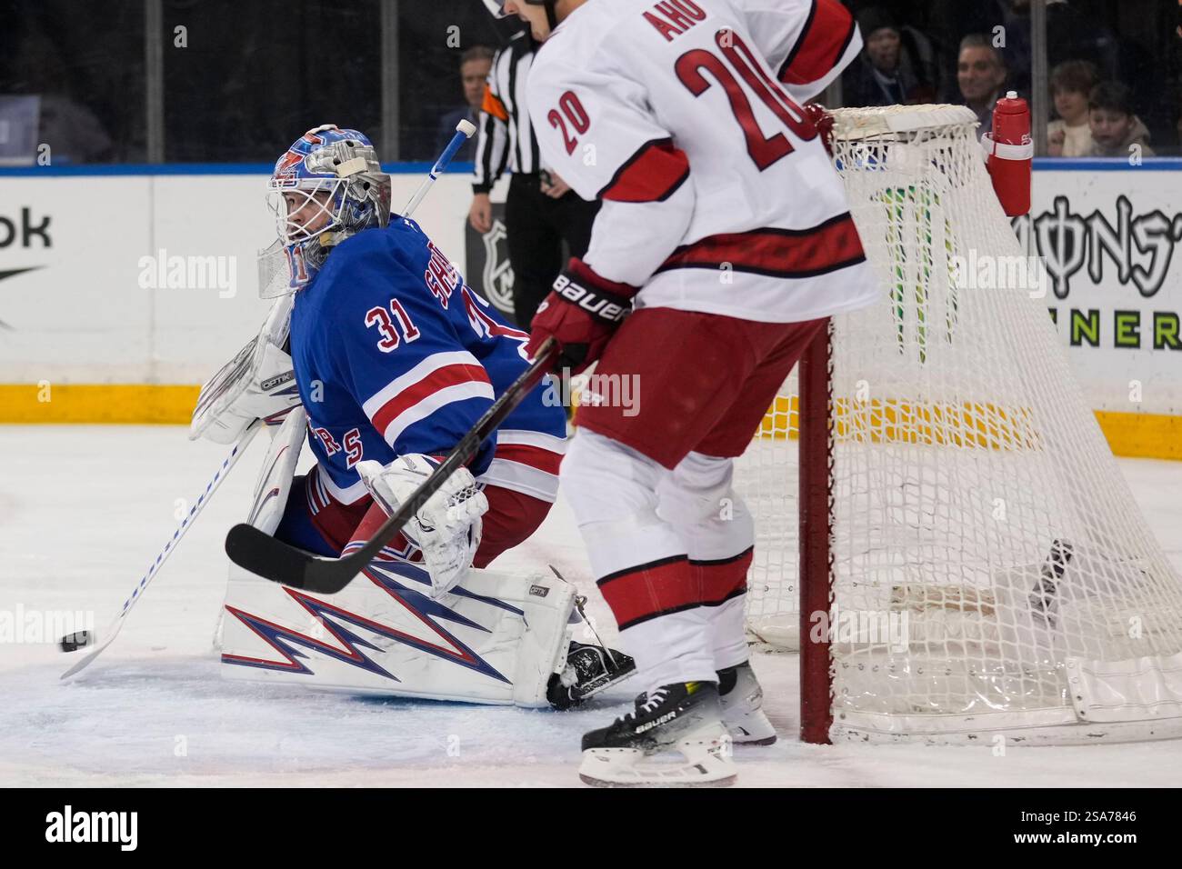 New York Rangers goaltender Igor Shesterkin, left, makes a save during ...