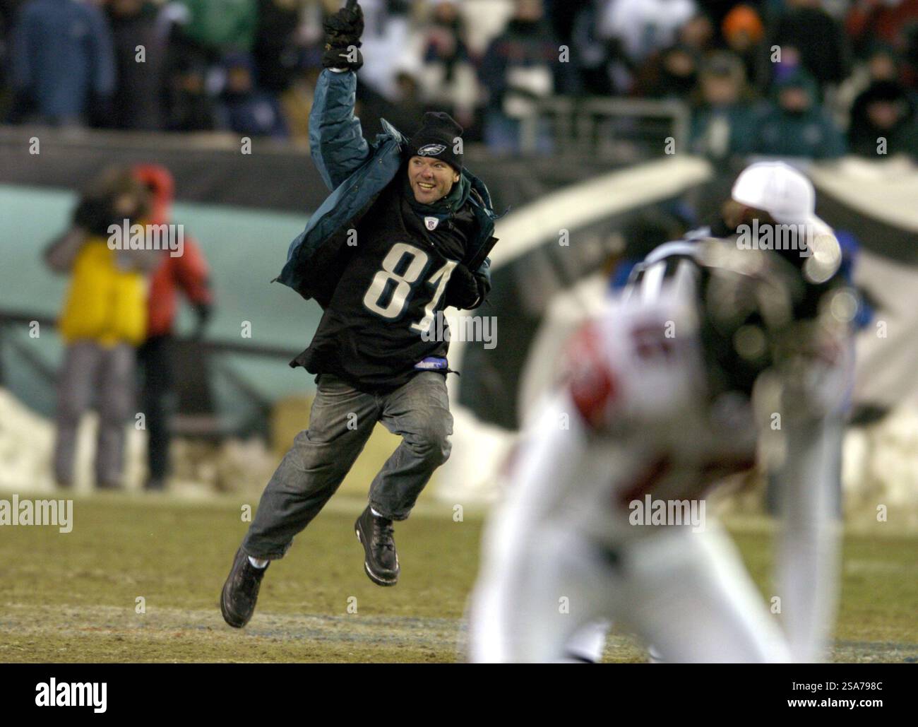 A Philadelphia Eagles fan wearing a No. 81 Terrell Owens jersey runs ...
