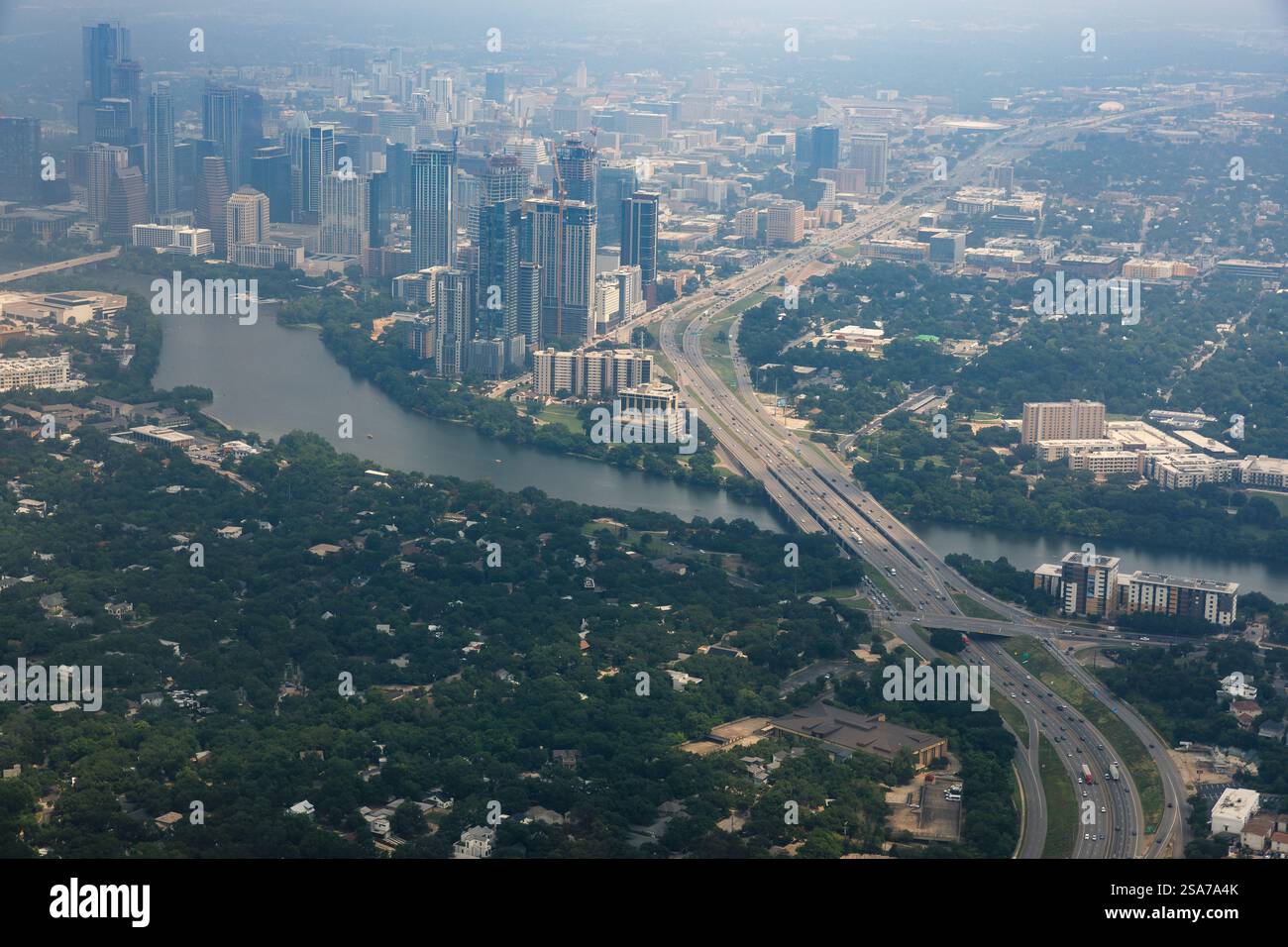 Aerial view downtown Austin with trees and highway bordering Town Lake ...