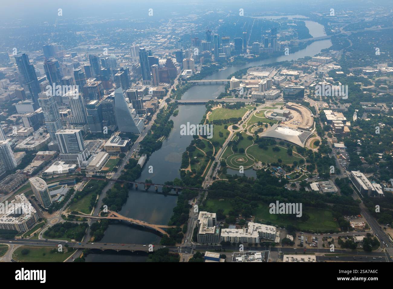 Aerial view downtown Austin with bridges and parks bordering Town Lake ...