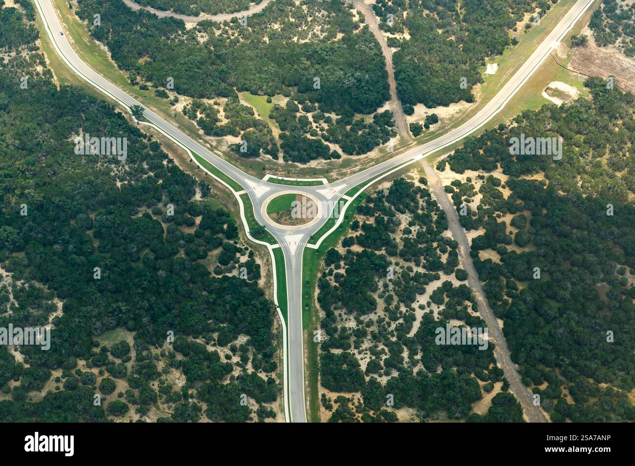 Aerial view of 3 roads converging on a highway roundabout Stock Photo ...