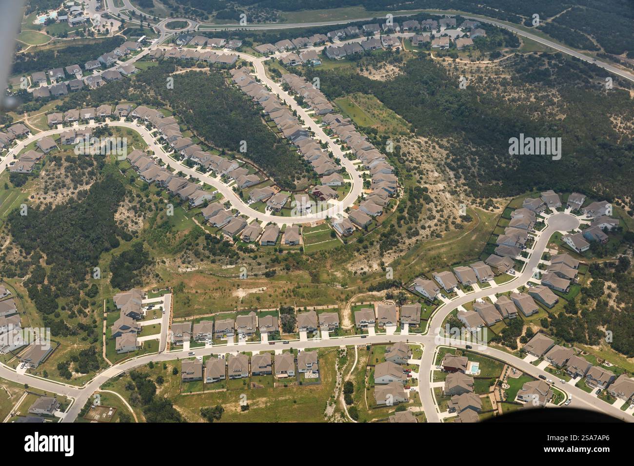 Aerial view of spiral pattern of tract housing suburban subdivision ...