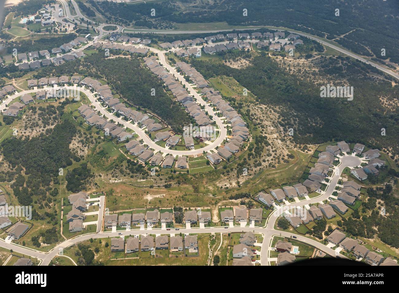 Aerial view of spiral pattern of tract housing suburban subdivision ...