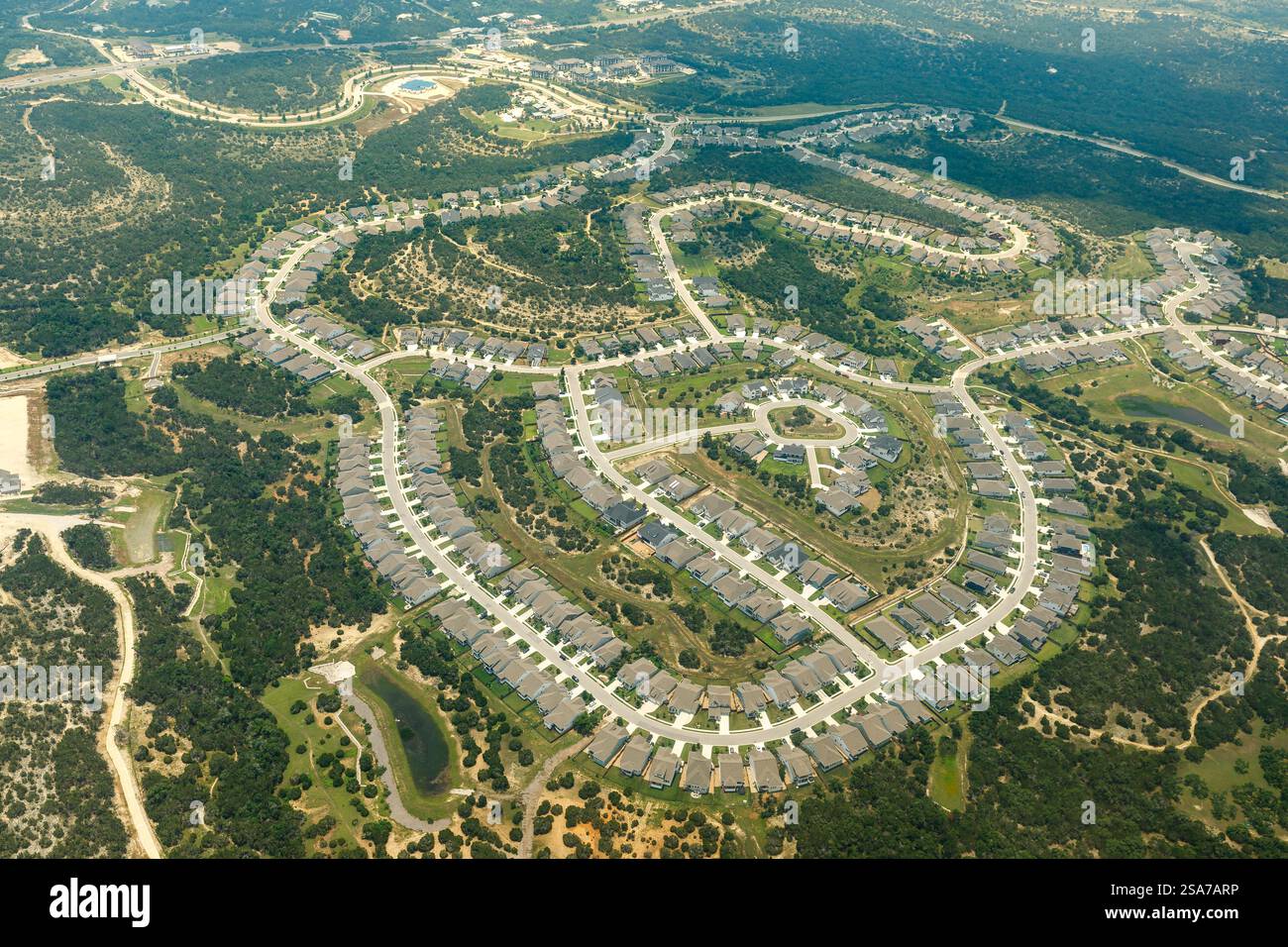 Aerial view of spiral pattern of tract housing suburban subdivision ...