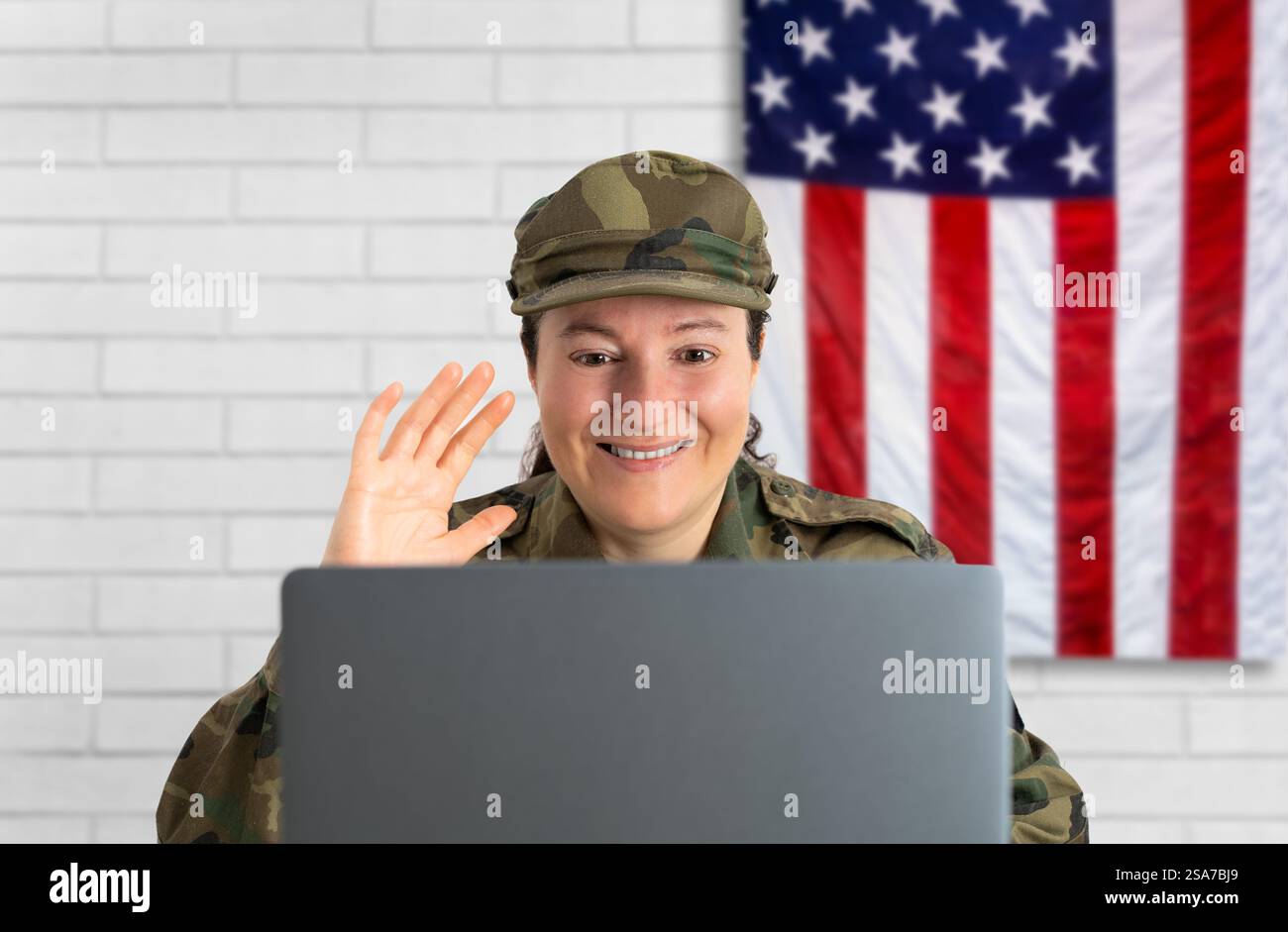 Happy female soldier smiling cheerfully while video calling her family ...