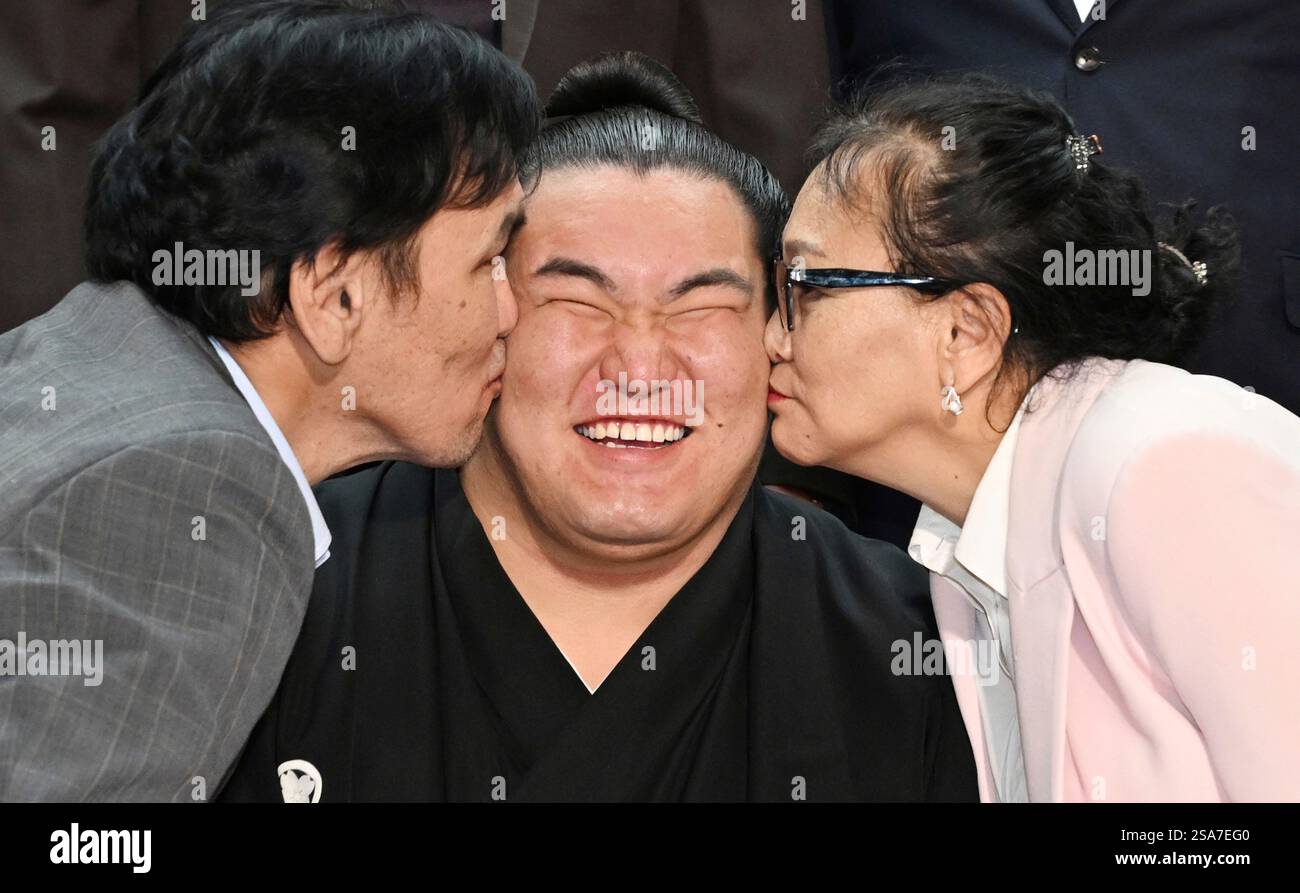 Hoshoryu, Mongolian Ozeki sumo wrestler（C）receives a kiss from his ...