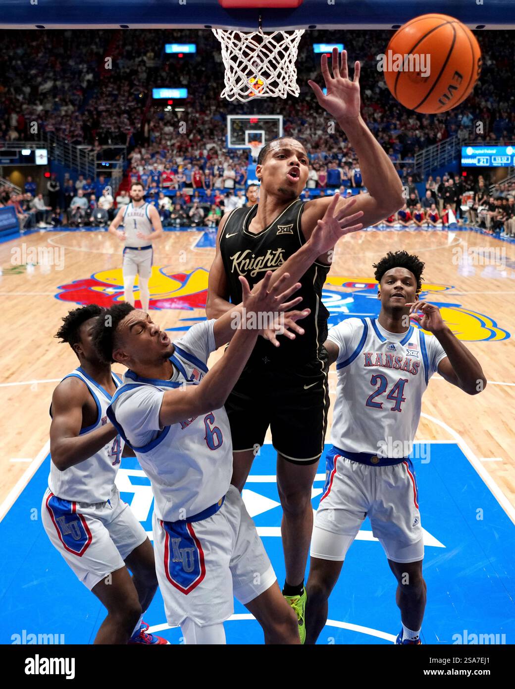 UCF guard Keyshawn Hall, center, battles Kansas guard Rylan Griffen (6 ...