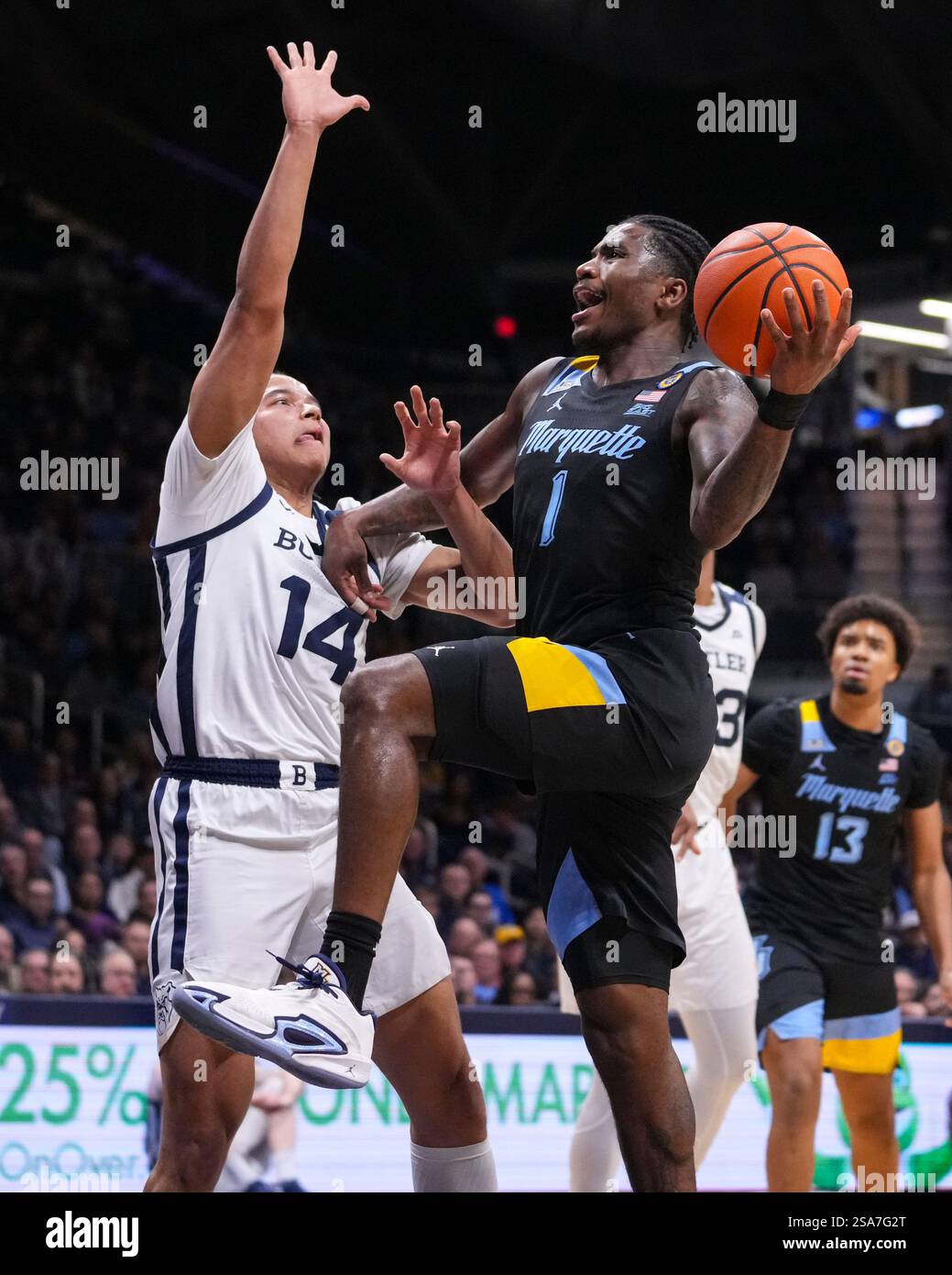Marquette guard Kam Jones (1) shoots over Butler guard Landon Moore (14 ...