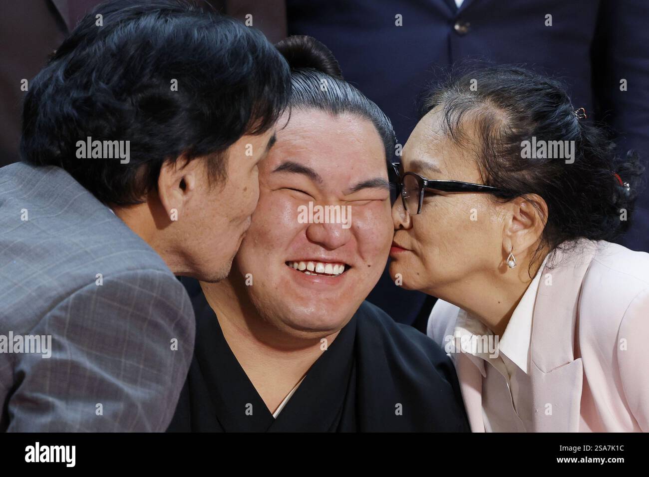 Mongolian sumo wrestler Hoshoryu (C) is kissed by his parents at his ...