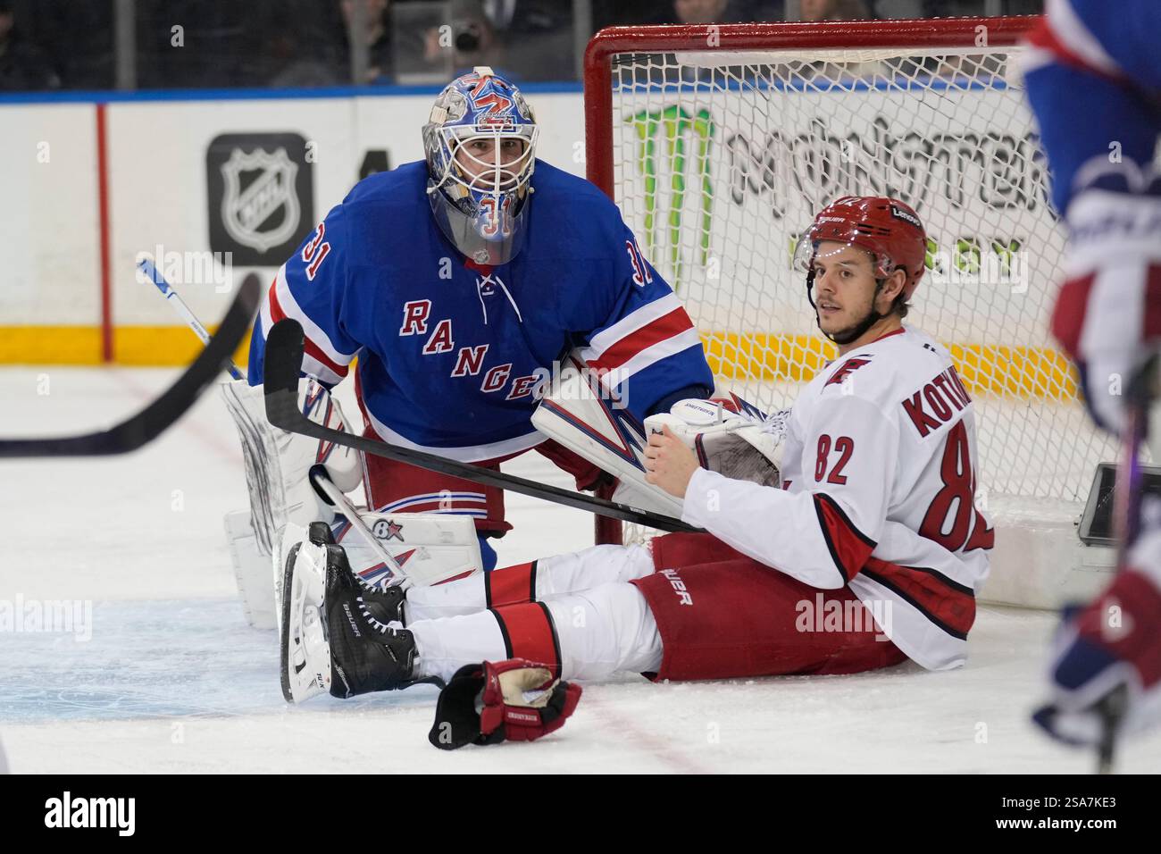 Carolina Hurricanes' Jesperi Kotkaniemi, left, slides into New York ...