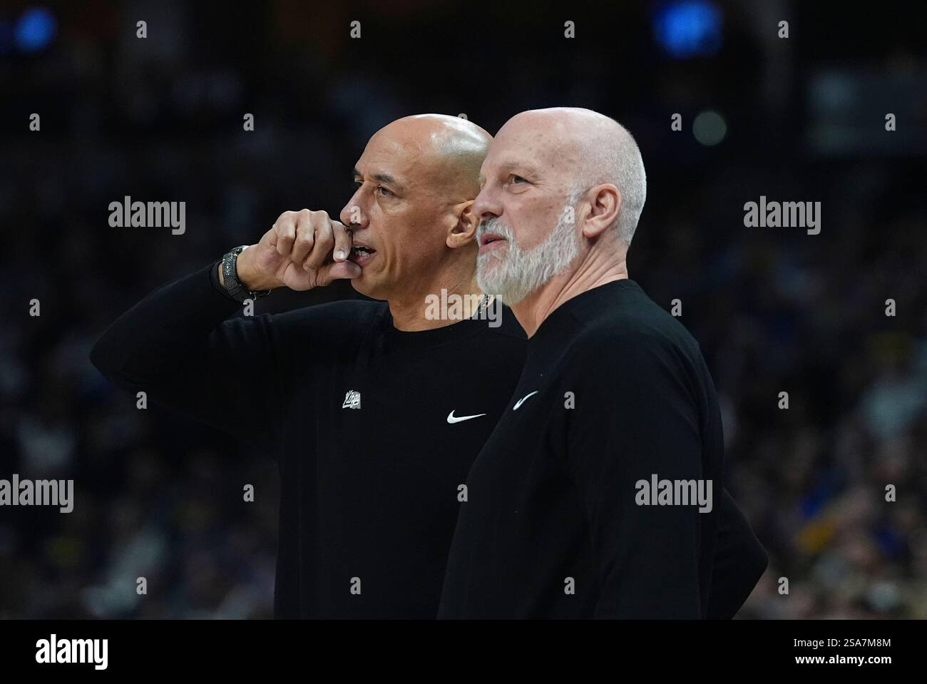 Sacramento Kings head coach Doug Christie, back, and assistant coach ...