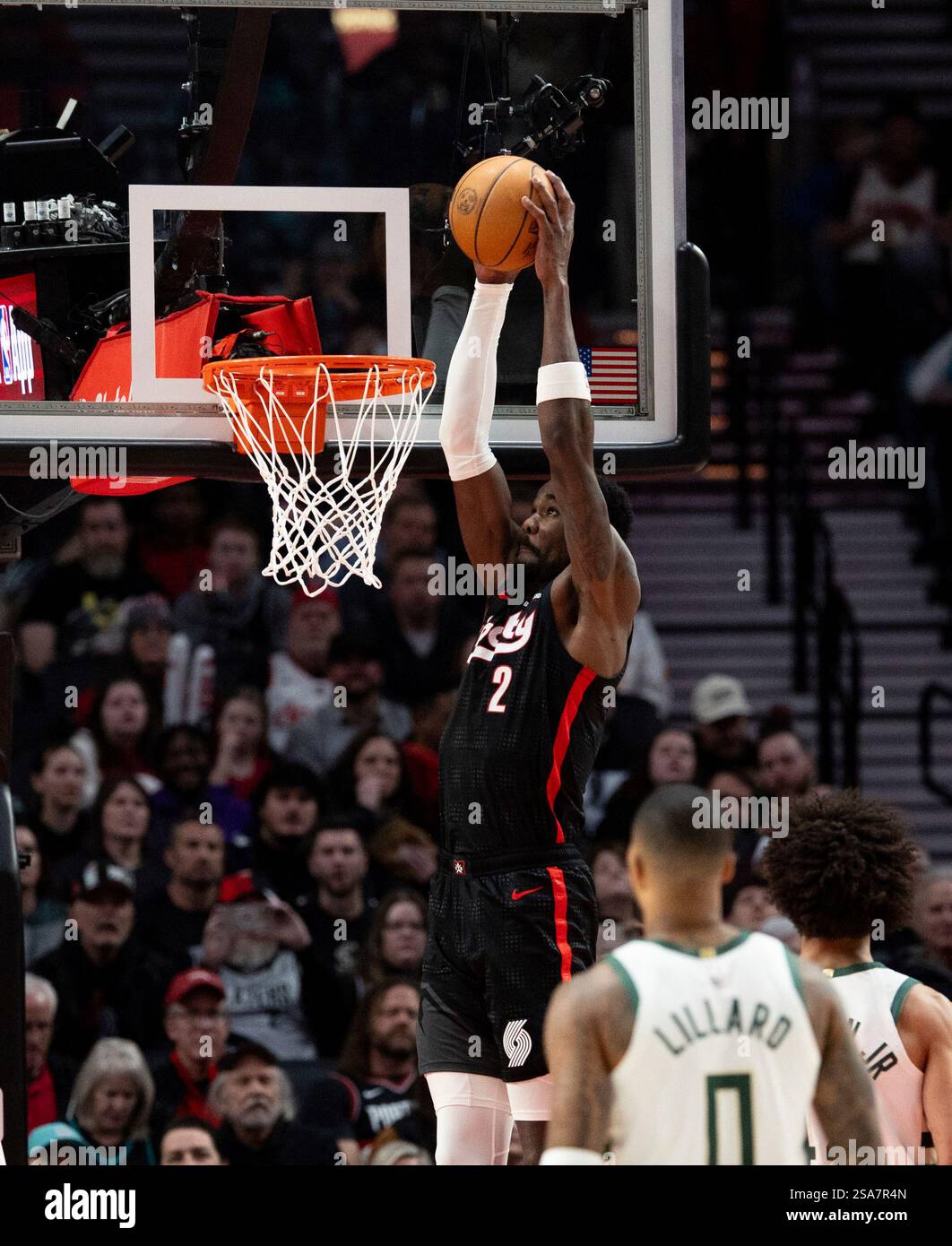 Portland Trail Blazers center Deandre Ayton, middle, dunks the ball against the Milwaukee Bucks ...