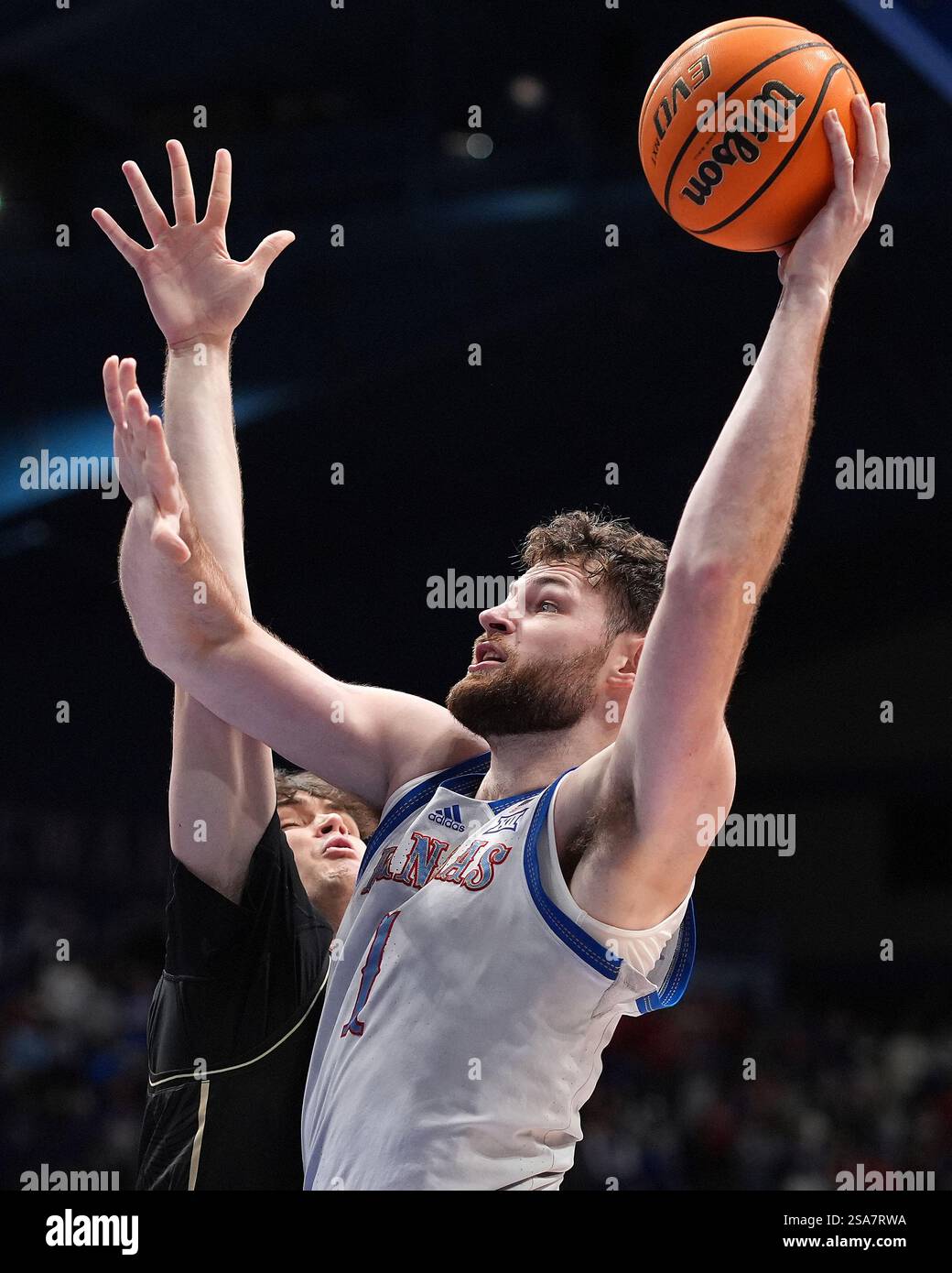 Kansas center Hunter Dickinson (1) shoots under pressure from UCF ...