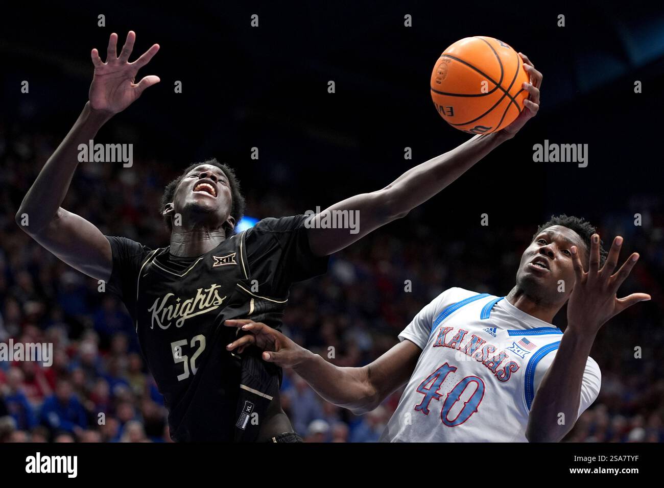 UCF center Moustapha Thiam (52) beats Kansas forward Flory Bidunga (40 ...