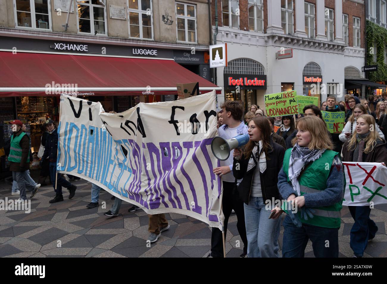Protesters hold a banner as they march during a demonstration against ...