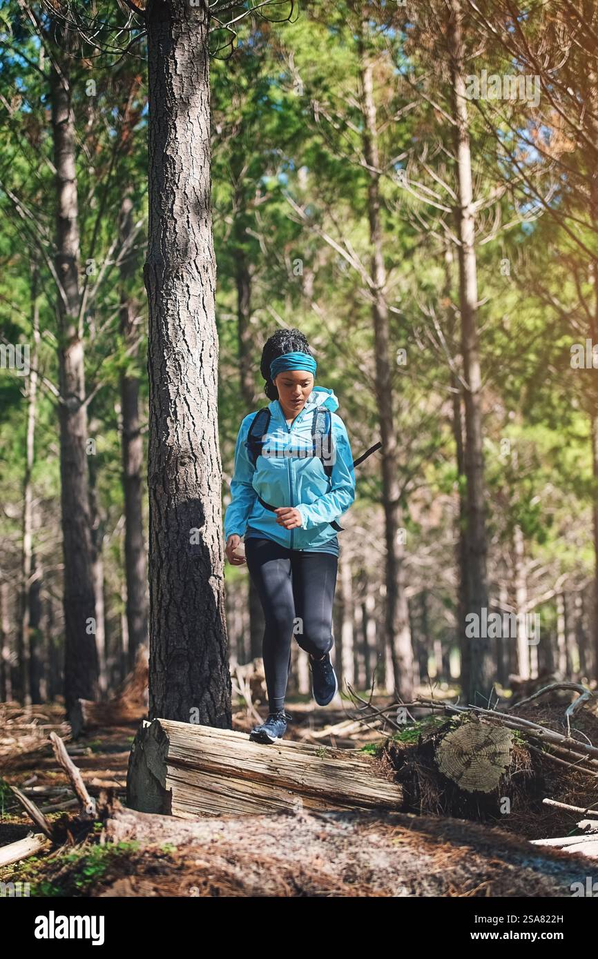 Fitness, running and woman in woods with trees, wellness and challenge ...