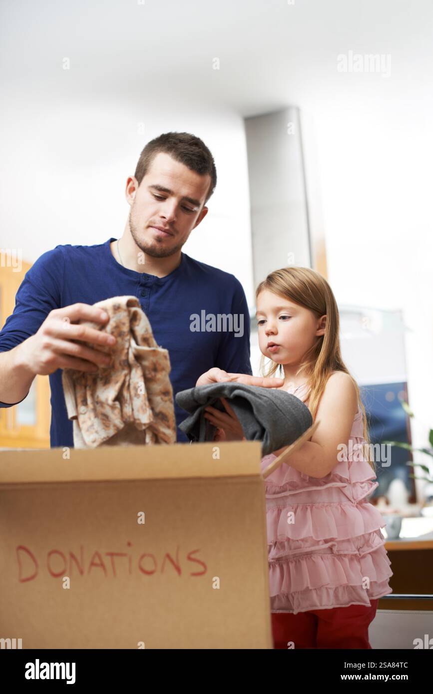 Parent, child and box with clothes for donation, promote sustainability ...