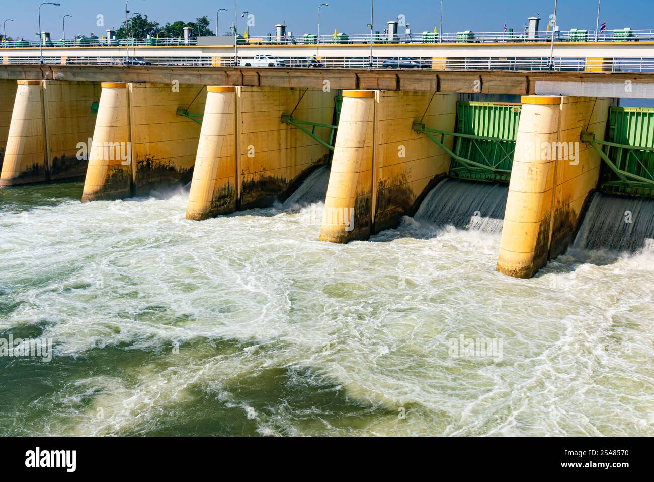 View of water flow through the gates of hydroelectric power station and ...