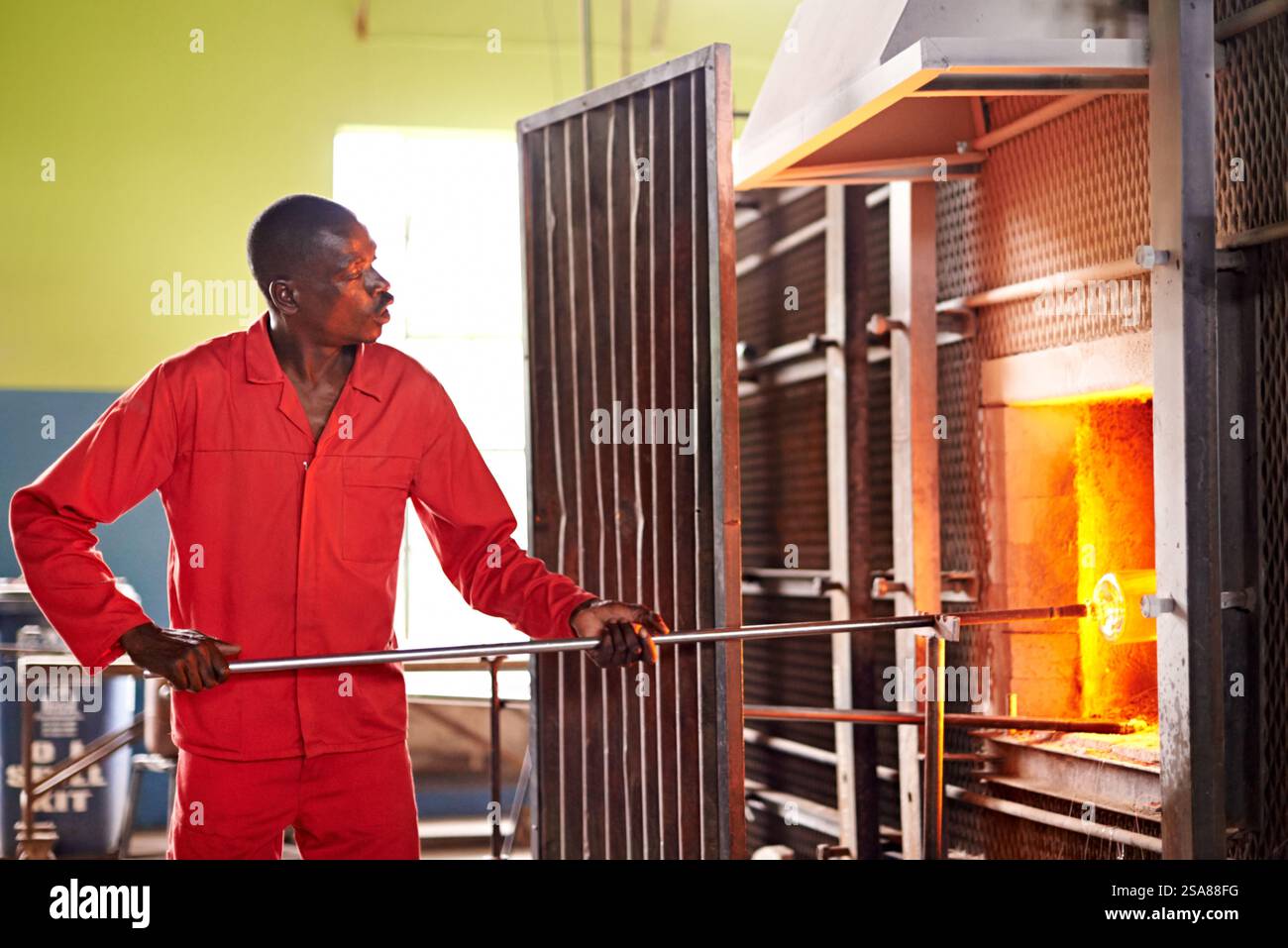 Furnace, artist and man in workshop with glass for manufacturing ...