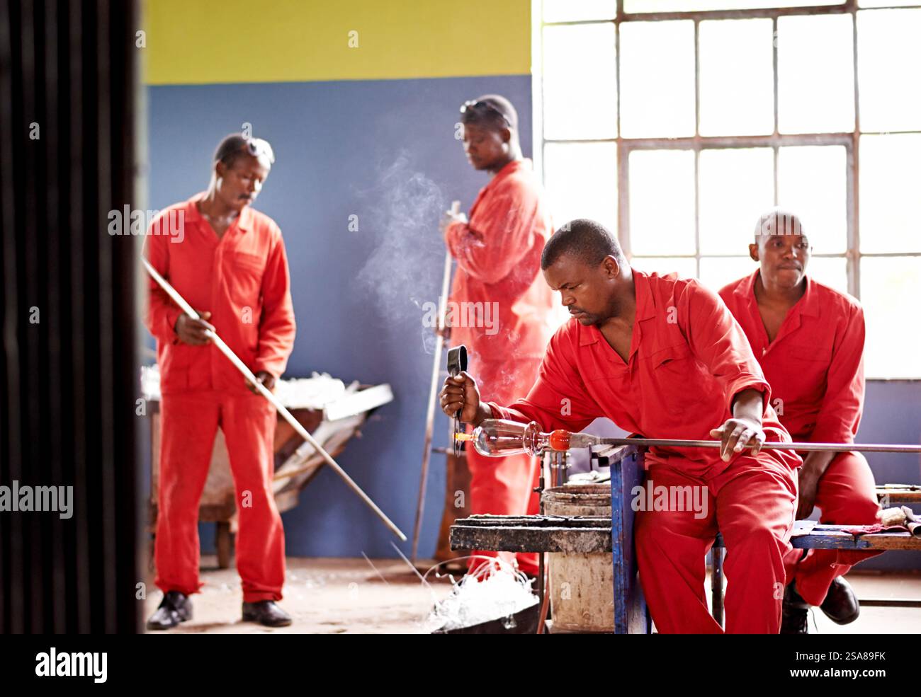 Glassblower, molding and man in factory with production and equipment ...