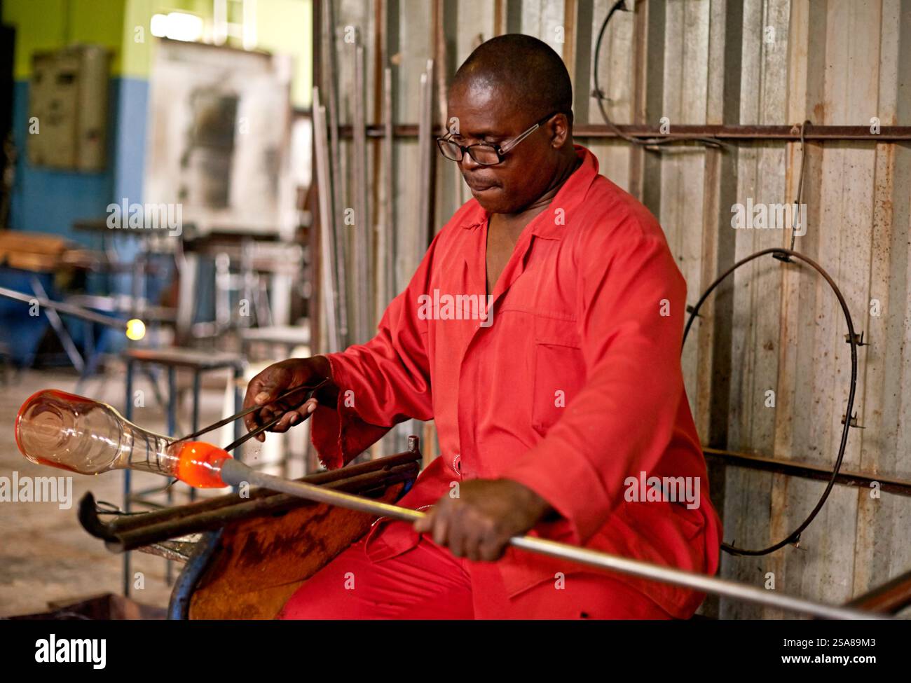 Glass, blowing and black man in craft workshop for small business with ...