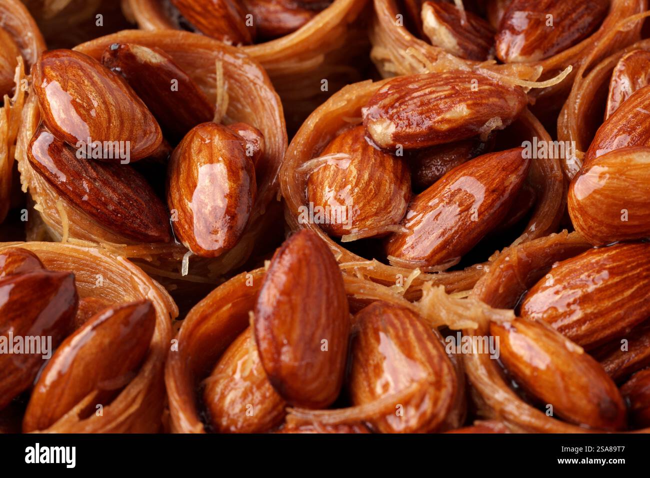 Delicious roasted nuts coated in sweet syrup displayed at a market in ...