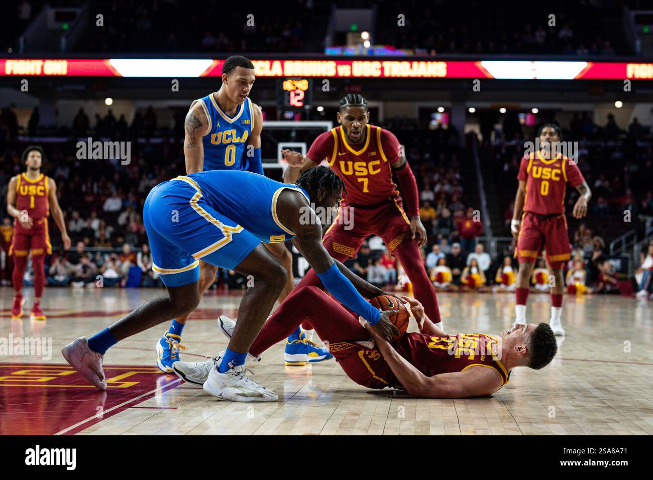 UCLA Bruins guard Eric Dailey Jr. (3) fights for possession with USC ...
