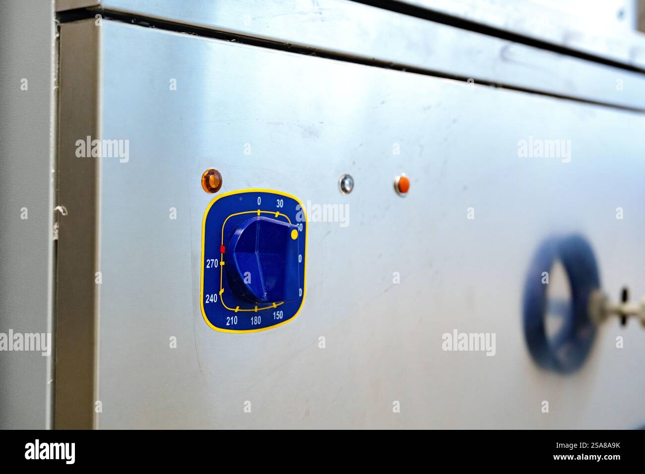 Dial control on a stainless steel kitchen appliance with indicator ...