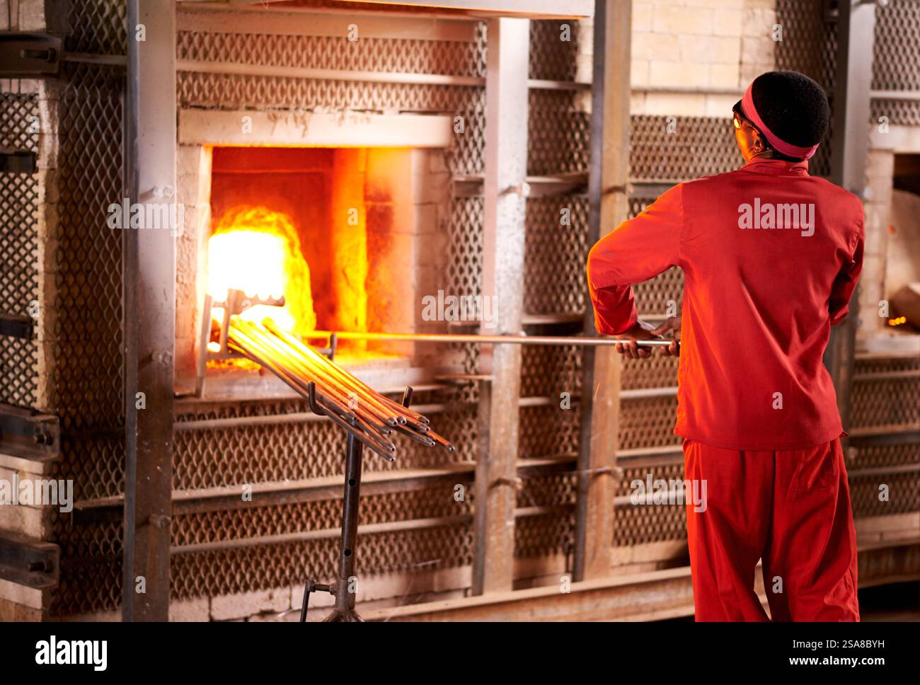 Furnace, industry and man in workshop with glass for manufacturing ...