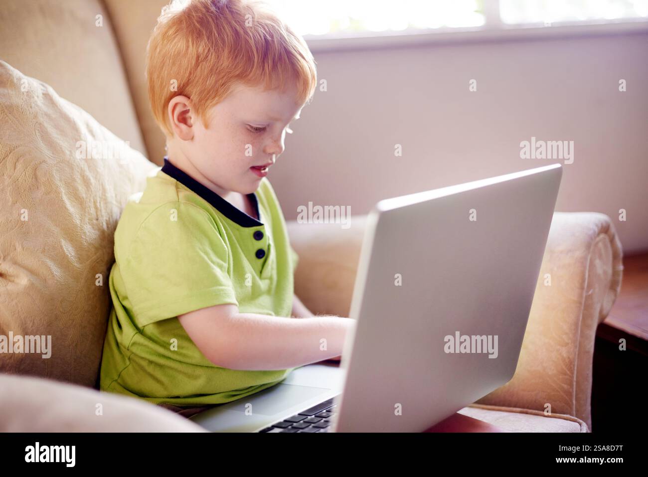 Education, serious and child with laptop, home and elearning for boy in ...