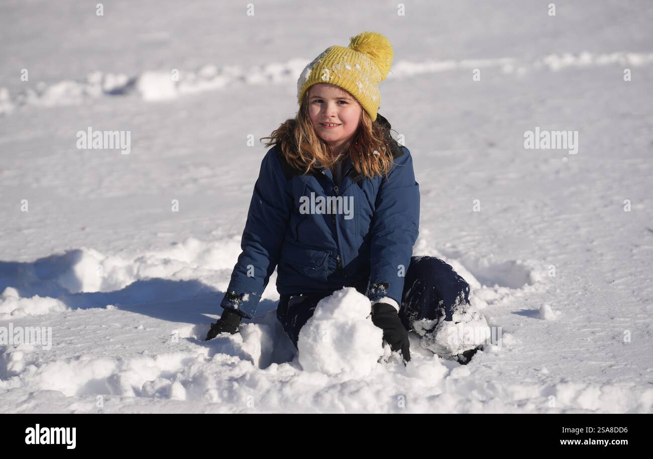 Kids Winter playing. Kid boy play in the snow with a winter hat. Happy ...