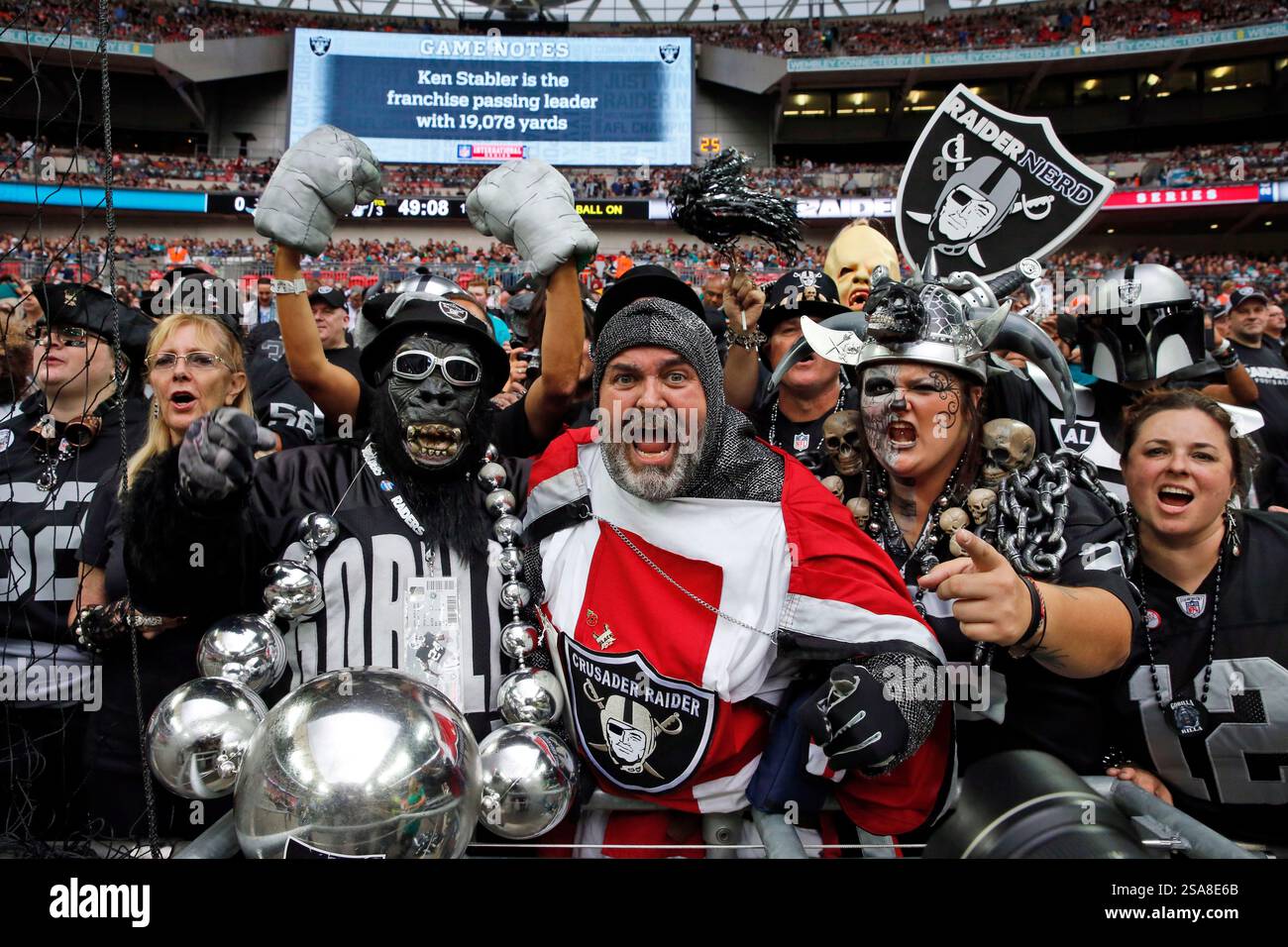 FILE - Oakland Raiders fans cheer for a photograph before an NFL ...