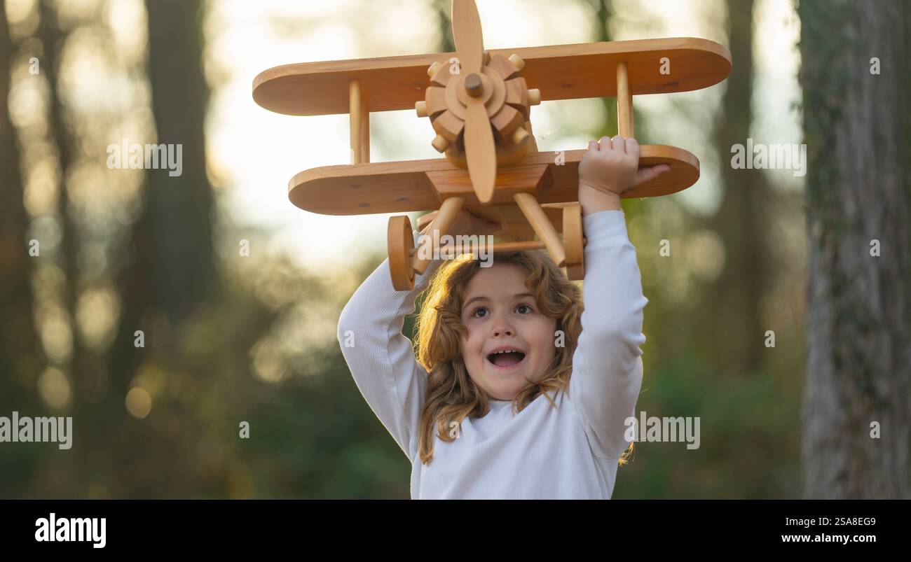 Kids dream. Kid play with wooden plane outdoor. Child playing with toy ...