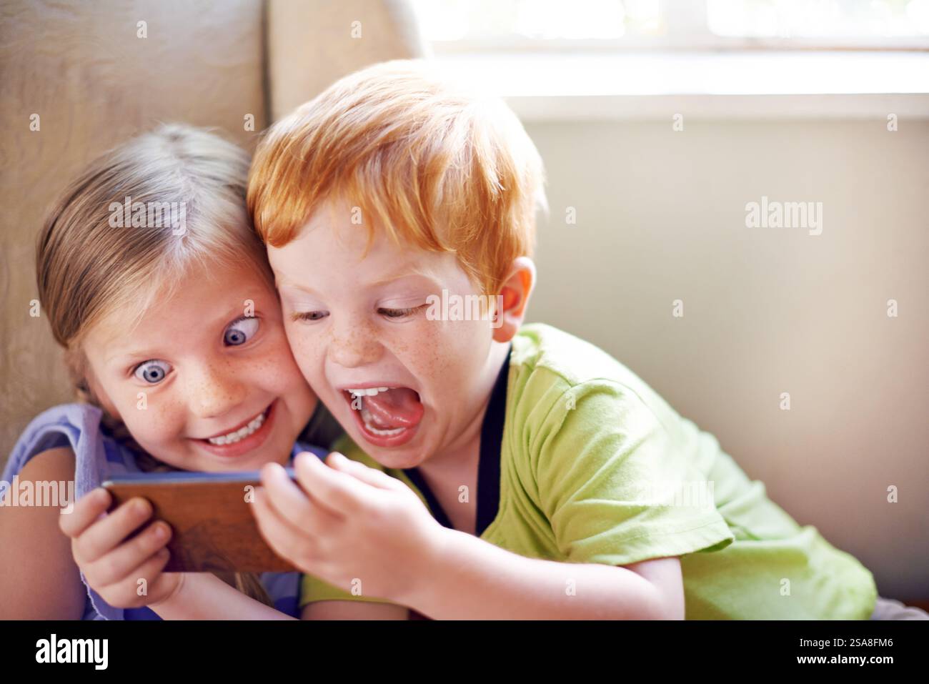 Funny face, family and children with selfie, home and smile for ...