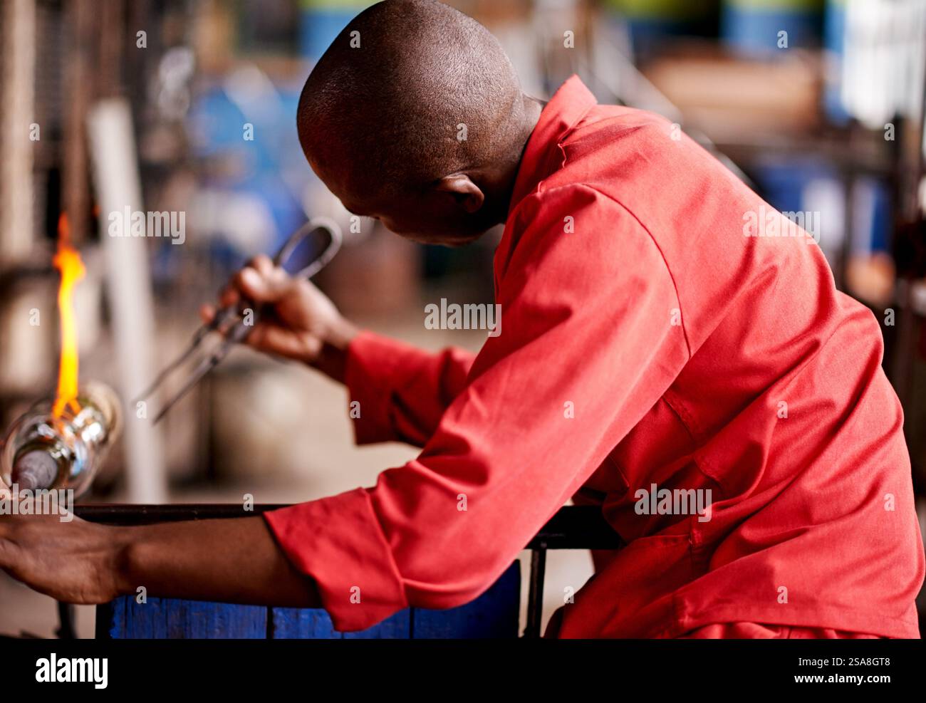 Glassblower, tools and black man in factory, skills and warehouse for ...