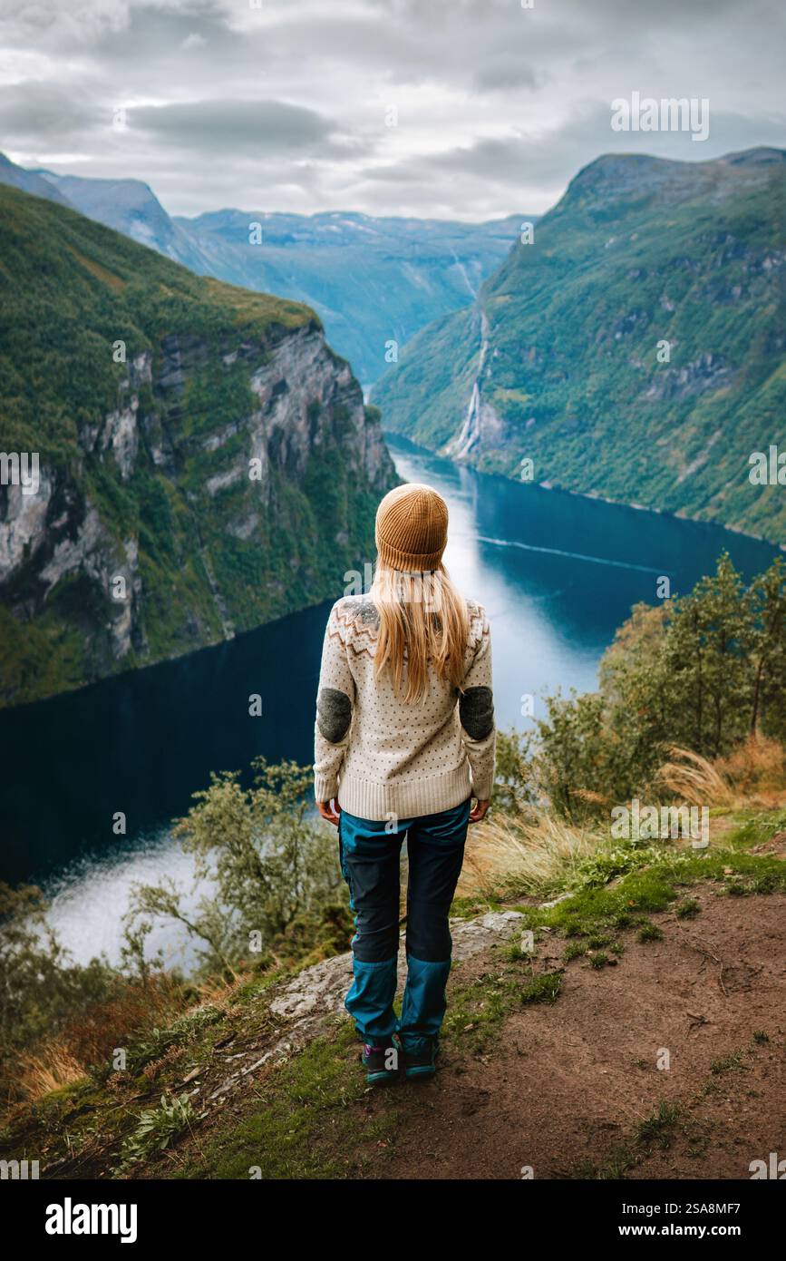 Woman tourist hiking in Norway alone sightseeing Geiranger fjord ...