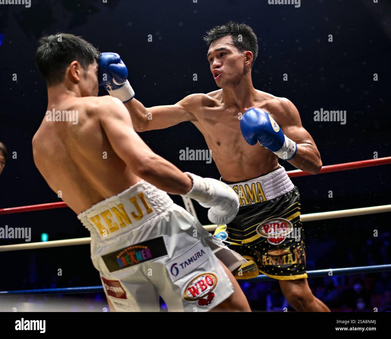 Champion Kenji Fujita (withe gloves) of Japan and challenger Michael Casama (blue gloves) of the ...