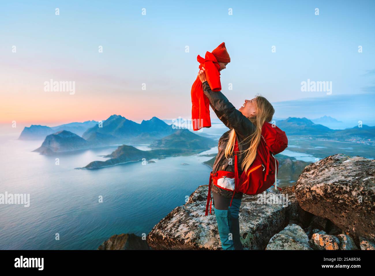 Family vacations in Norway - mother lifting up infant baby outdoor ...