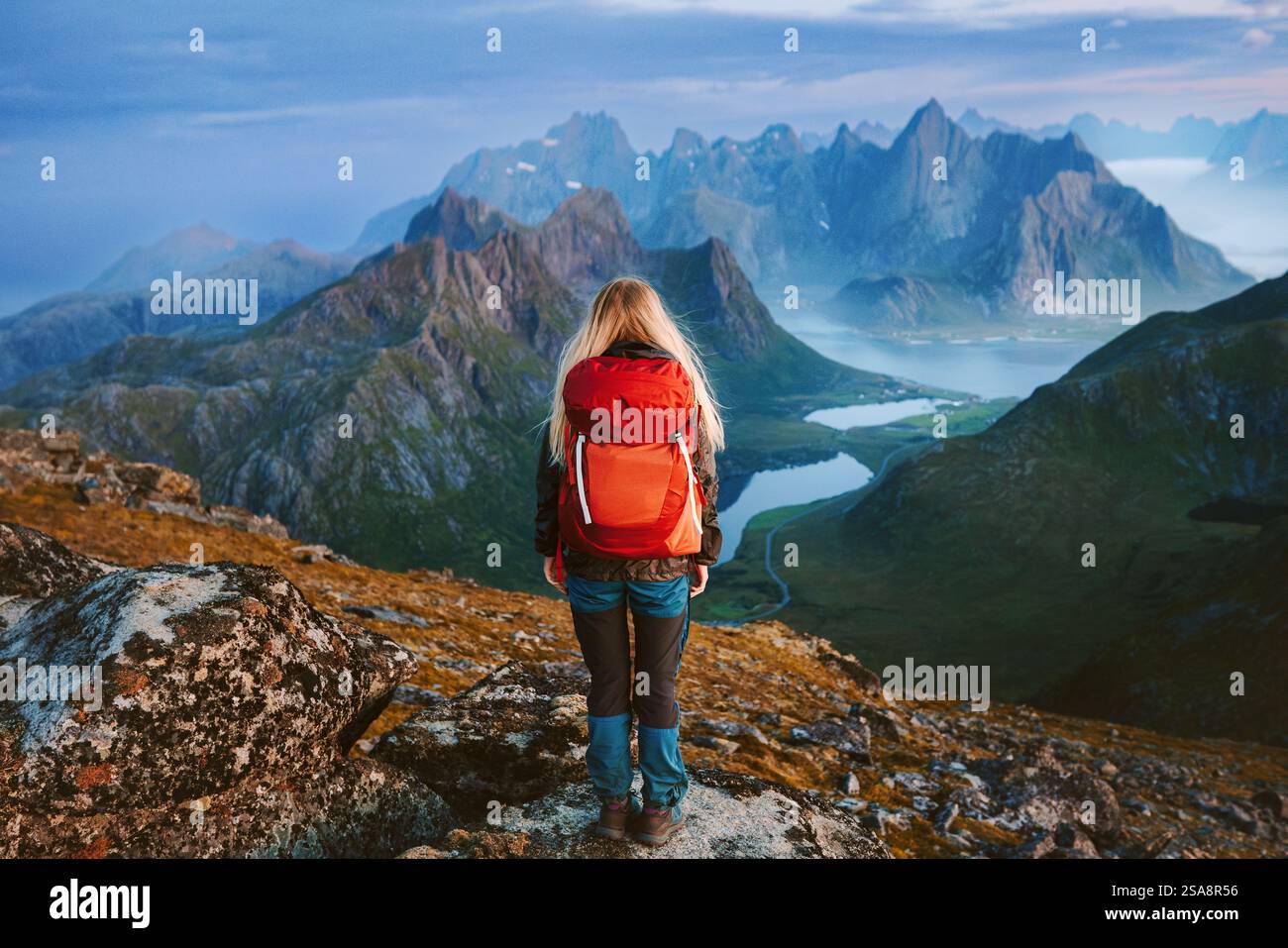 Woman backpacker hiking solo in Norway travel lifestyle female traveler ...