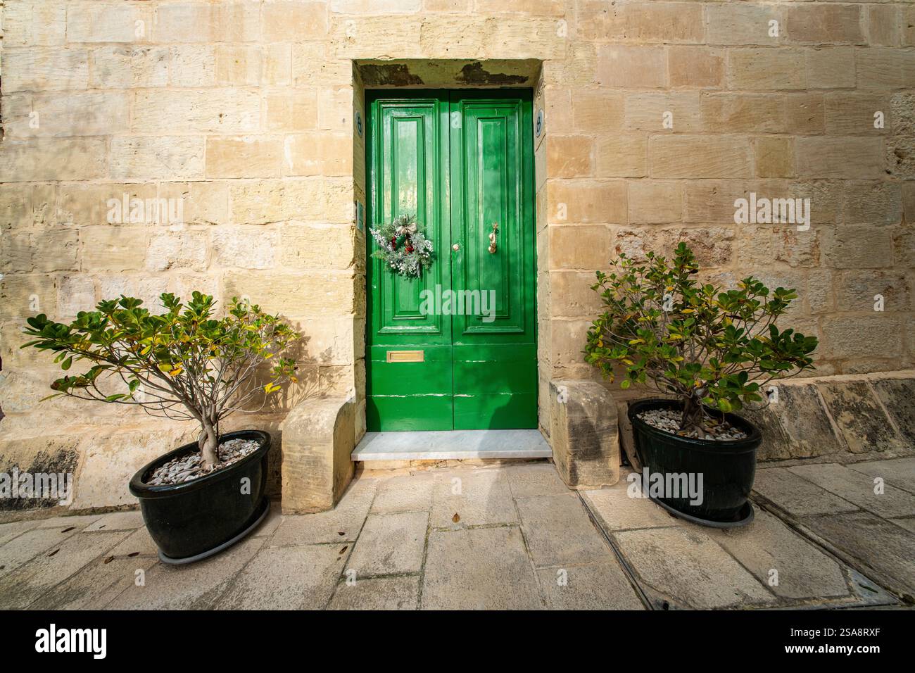 Traditional house detail in Malta. Limestone yellow bricks and colorful ...