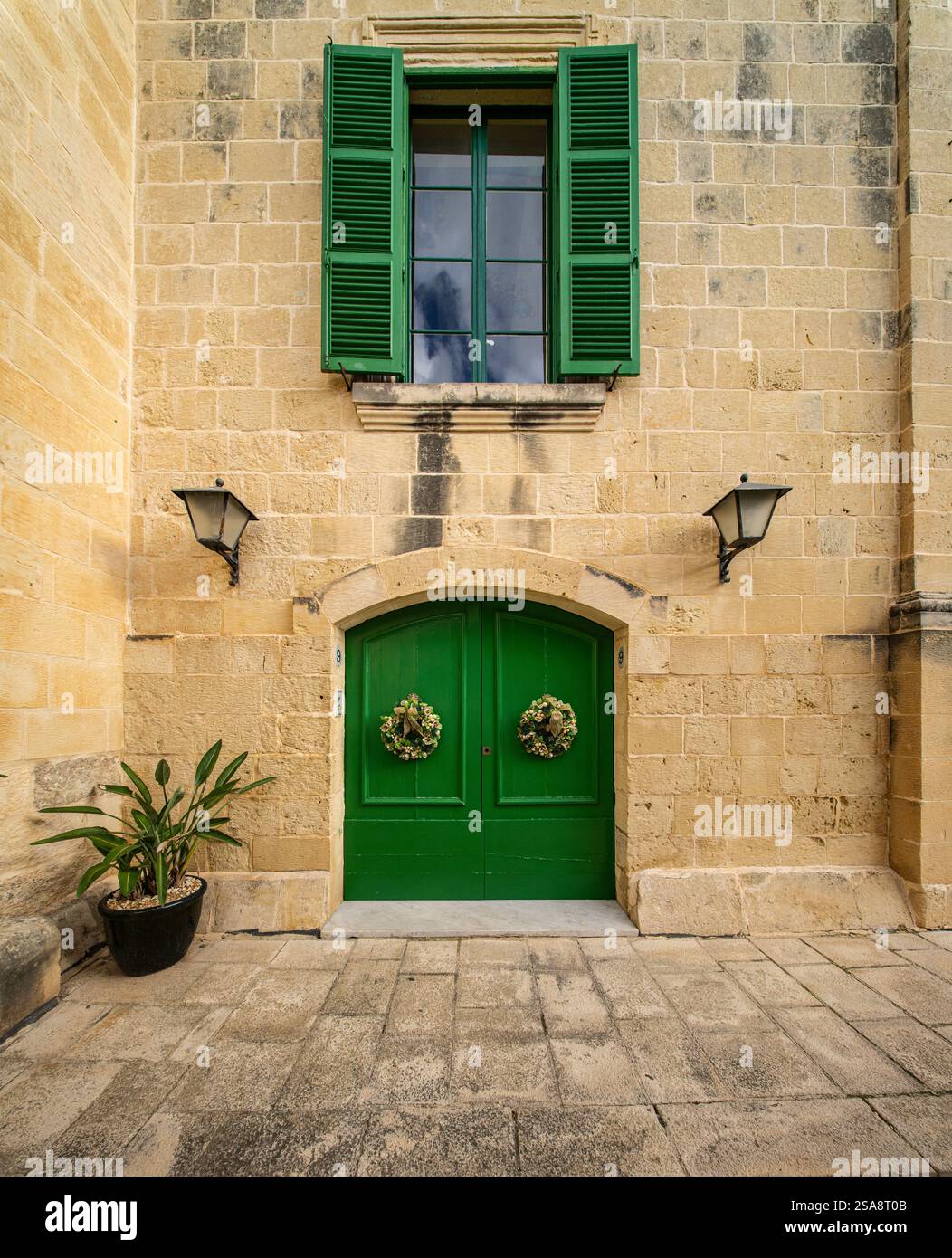 Traditional house detail in Malta. Limestone yellow bricks and colorful ...