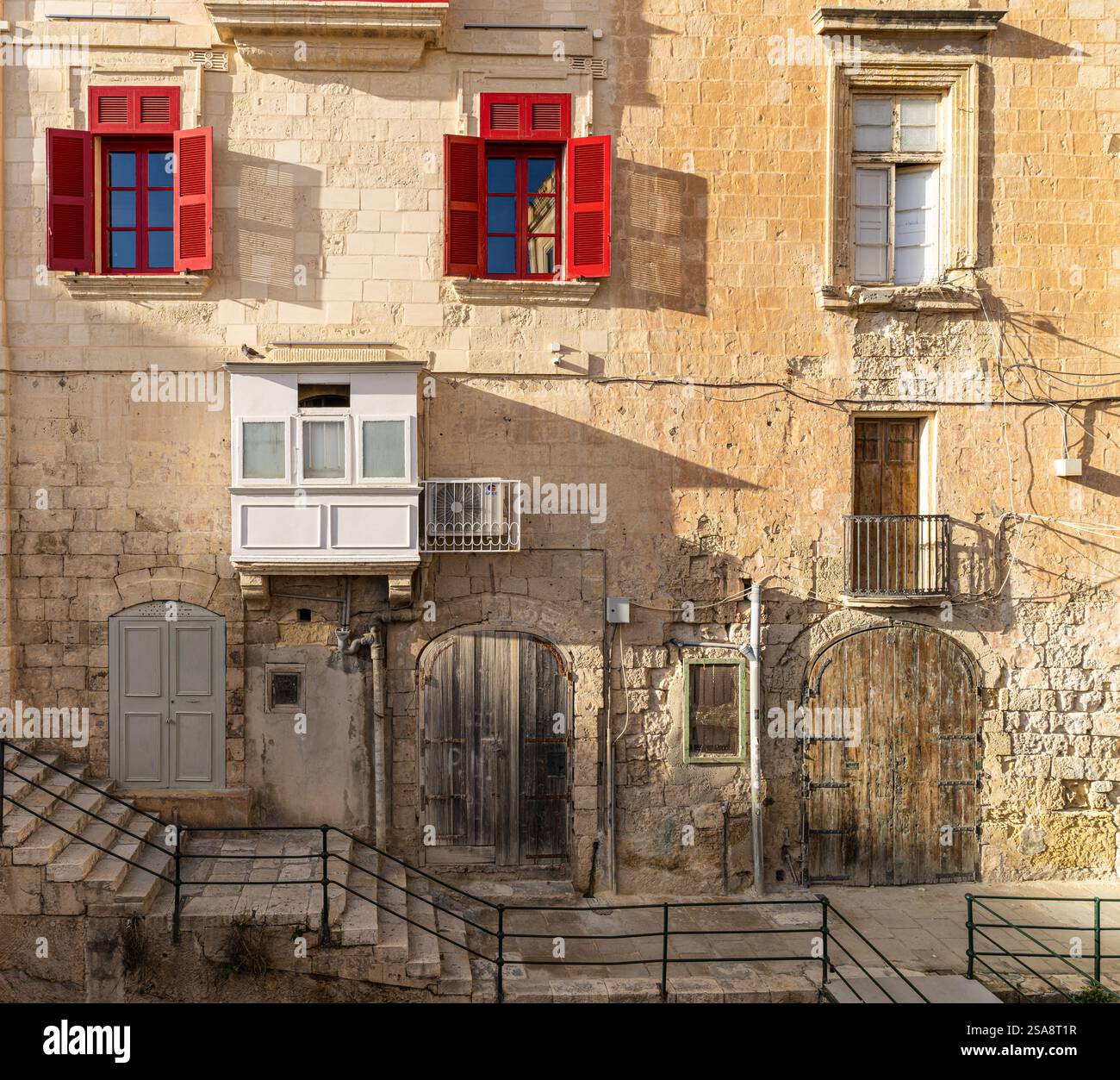 Traditional house detail in Malta. Limestone yellow bricks and colorful ...