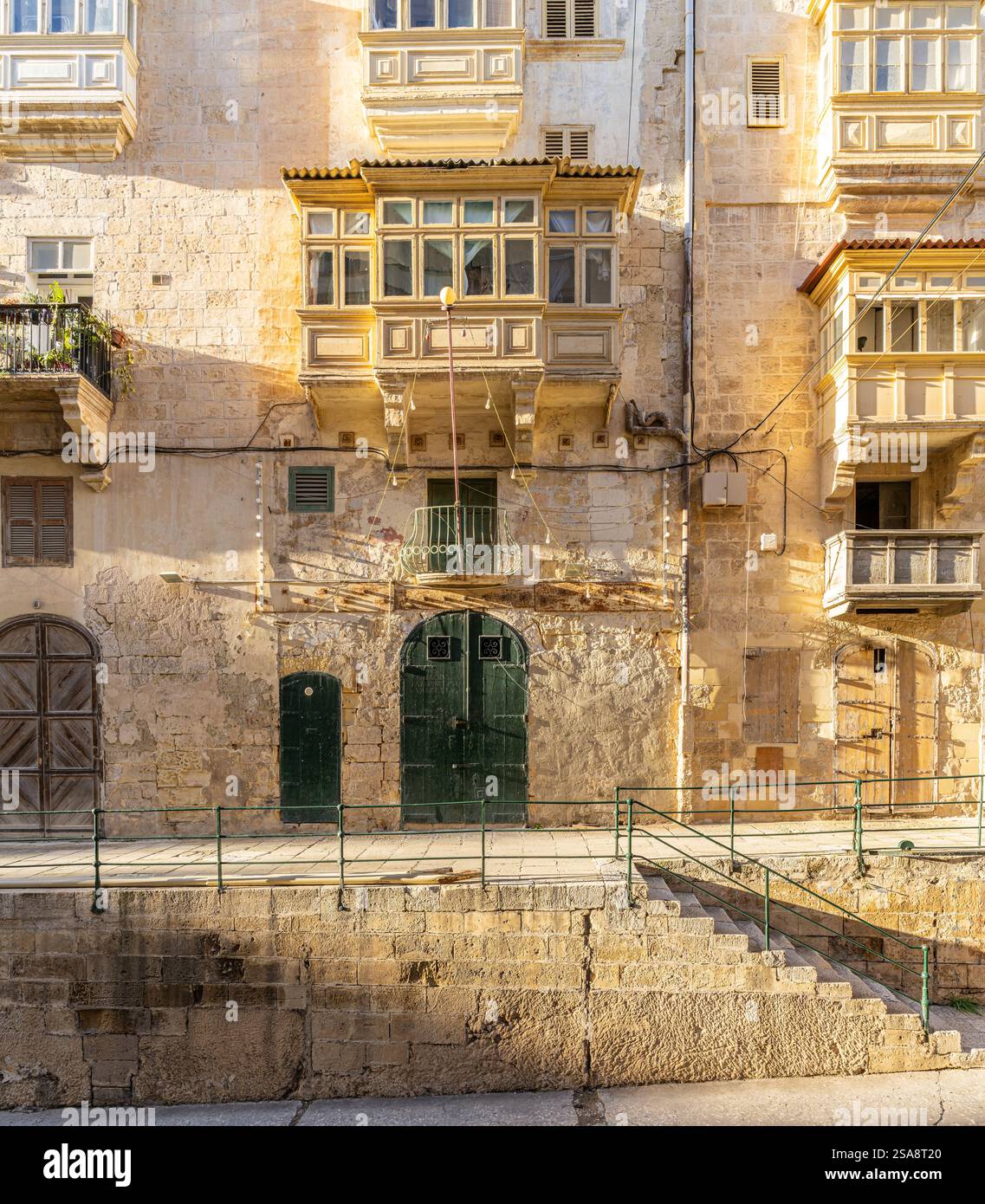 Traditional house detail in Malta. Limestone yellow bricks and colorful ...
