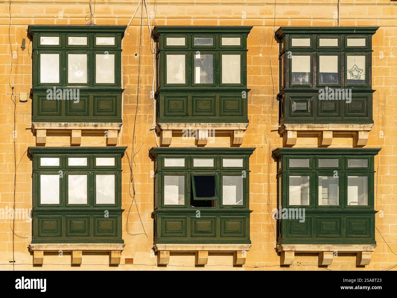 Traditional house detail in Malta. Limestone yellow bricks and colorful ...