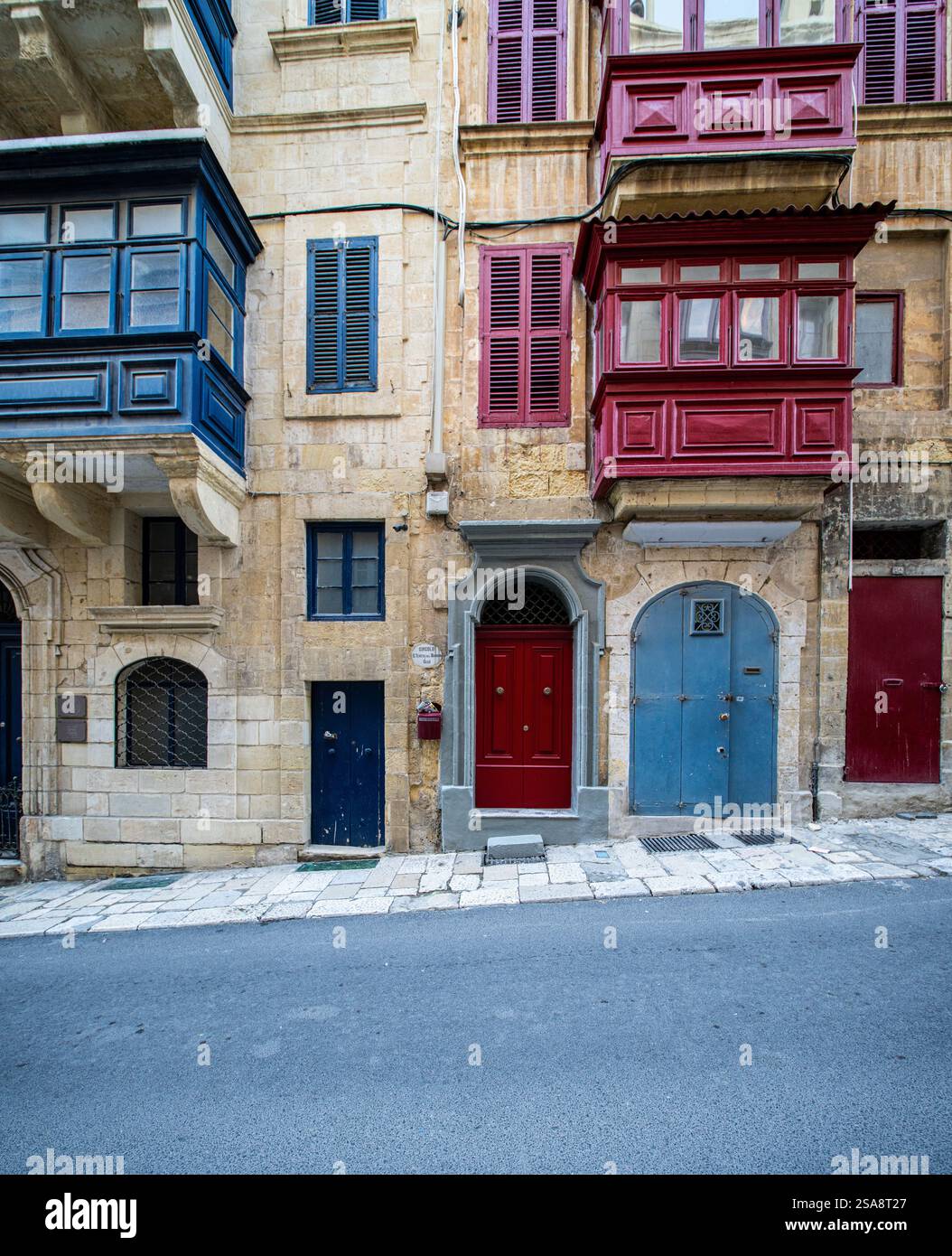 Traditional house detail in Malta. Limestone yellow bricks and colorful ...