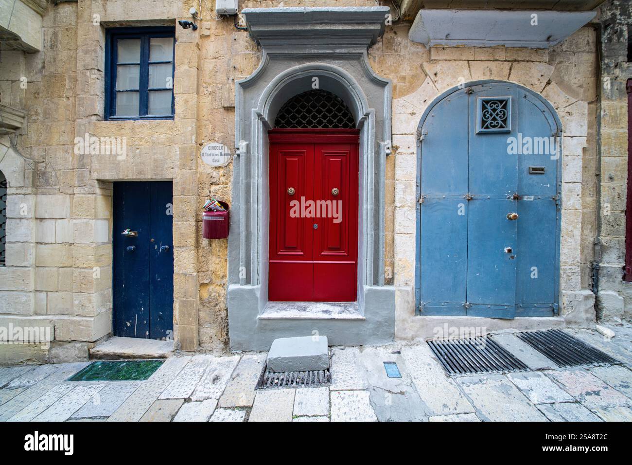 Traditional house detail in Malta. Limestone yellow bricks and colorful ...
