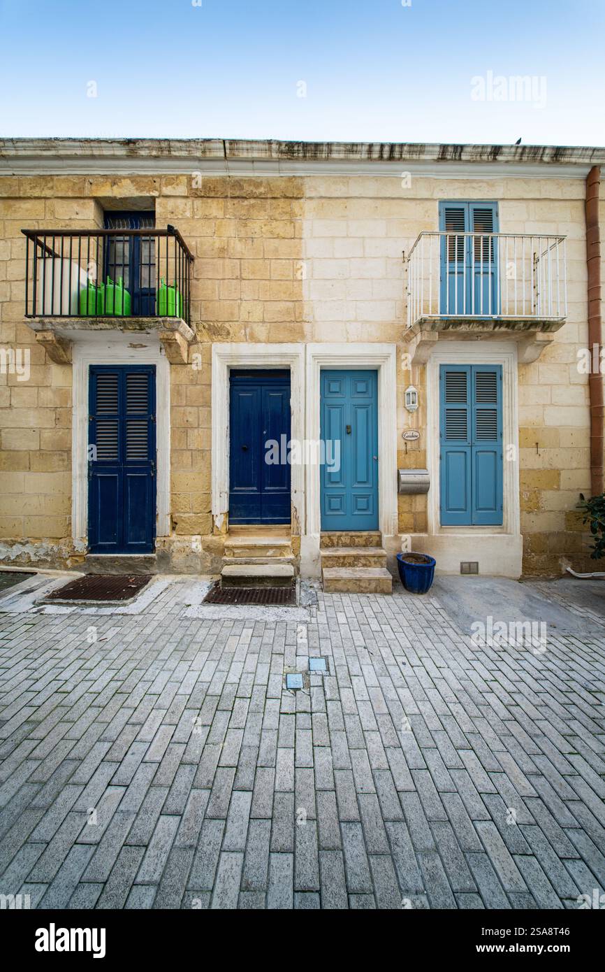 Traditional house detail in Malta. Limestone yellow bricks and colorful ...