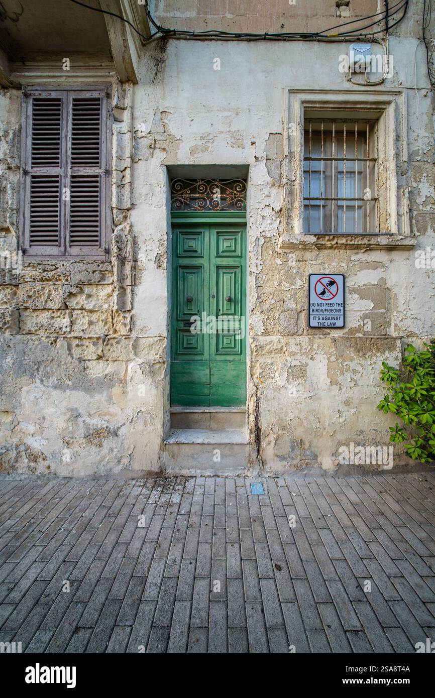 Traditional house detail in Malta. Limestone yellow bricks and colorful ...
